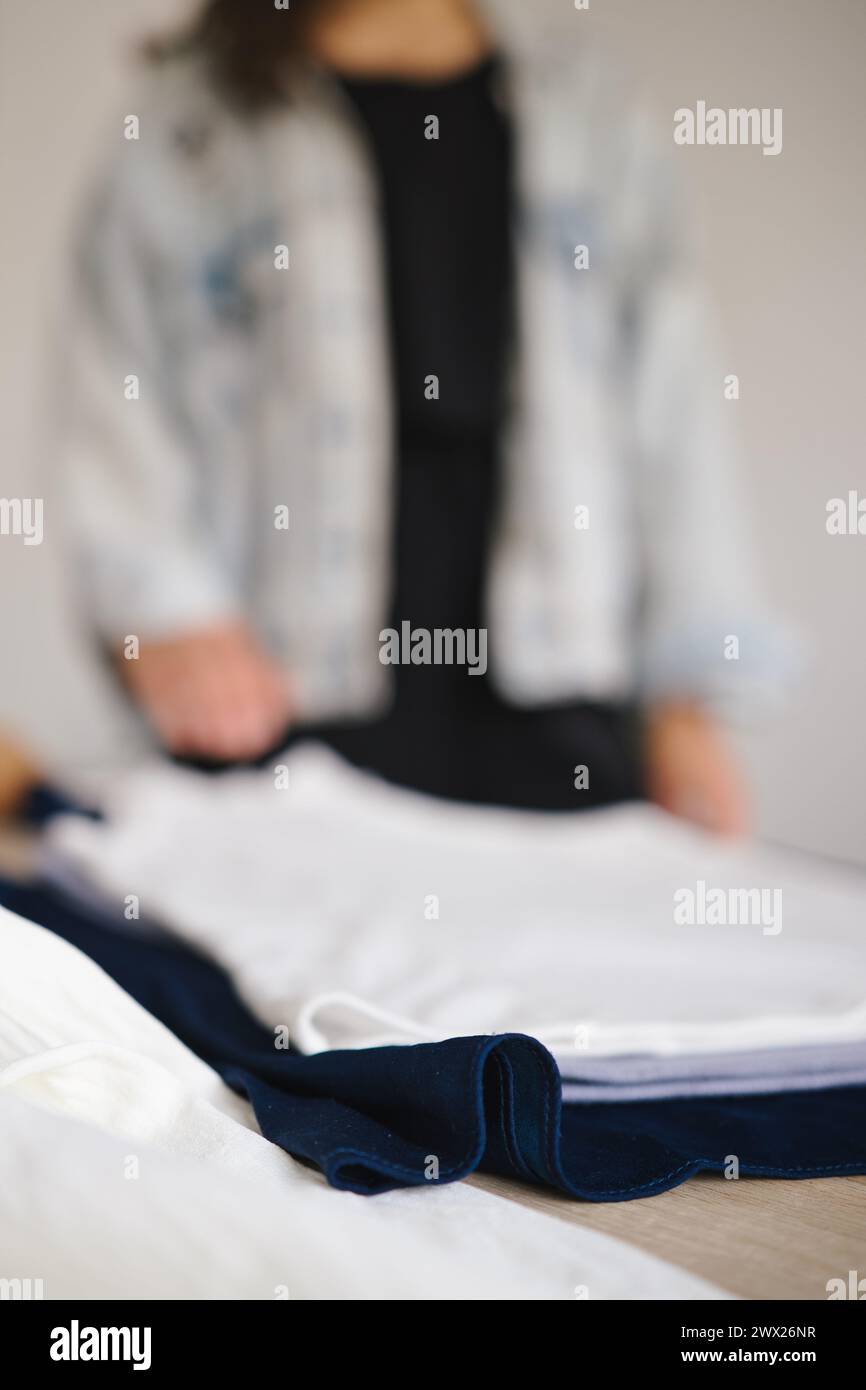 Woman selecting fabrics in clothing manufacturing process. Fitting room ...