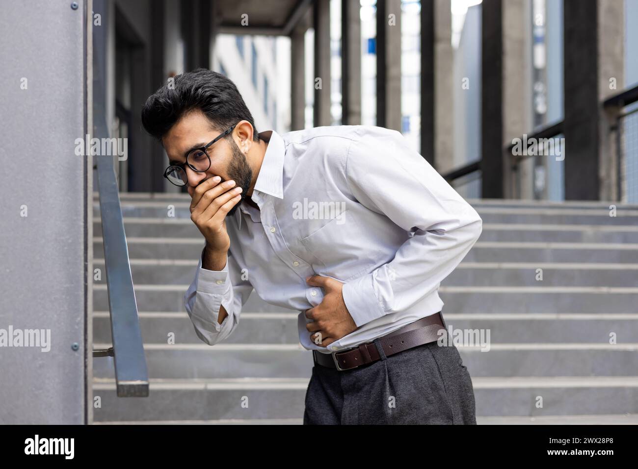 Indian young male office worker, student standing near building and ...