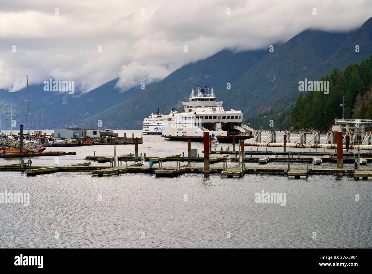 Two BC ferries leaving the Horseshoe Bay ferry terminal with green ...