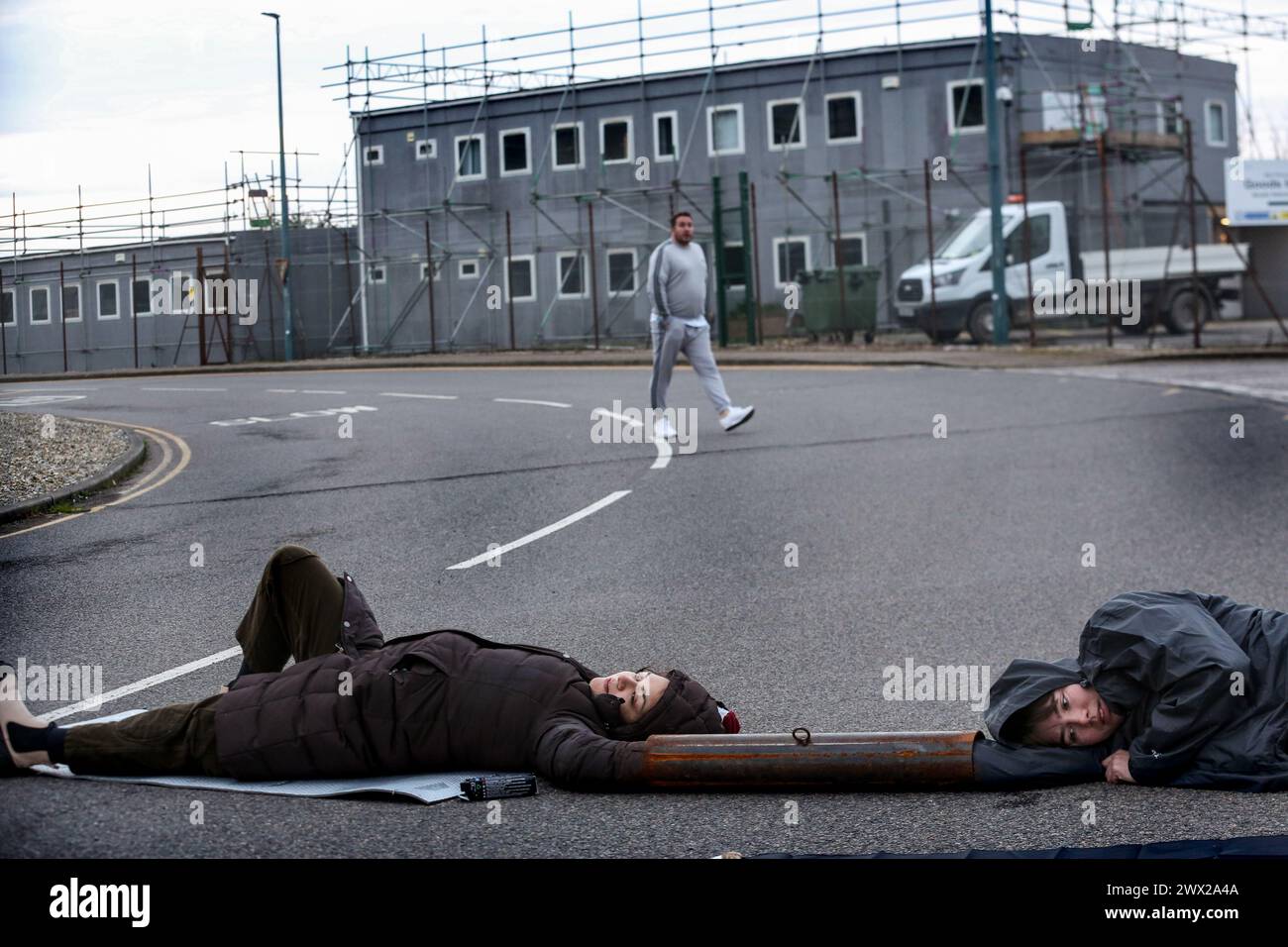 A worker walks into work as activists from Palestine Action attach ...