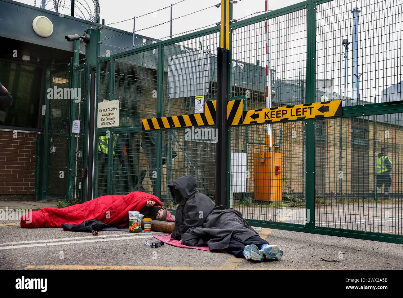 Activists from Palestine Action lay on the ground blocking gate access ...