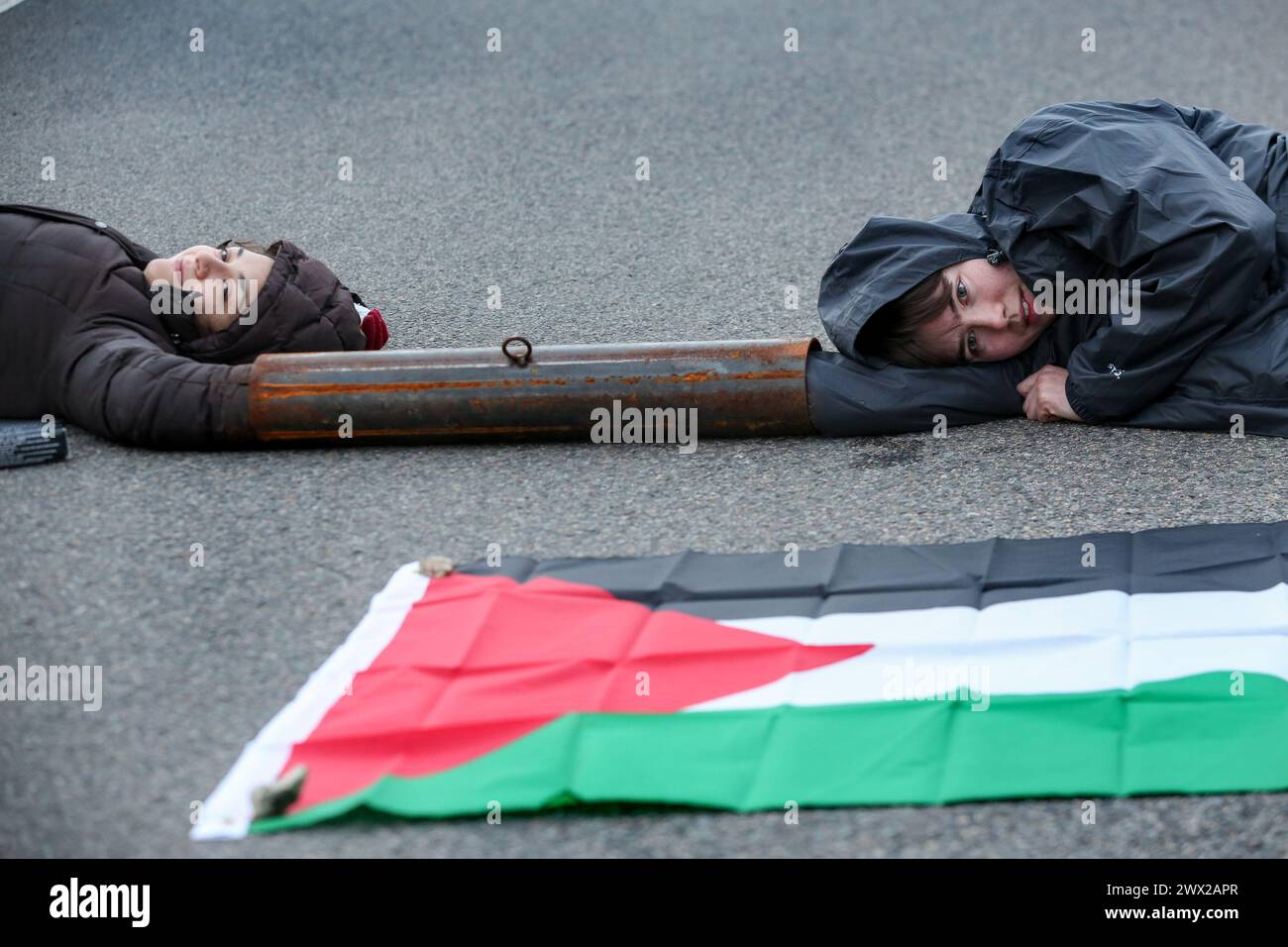 Activists from Palestine Action attach themselves to a metal lock-on ...
