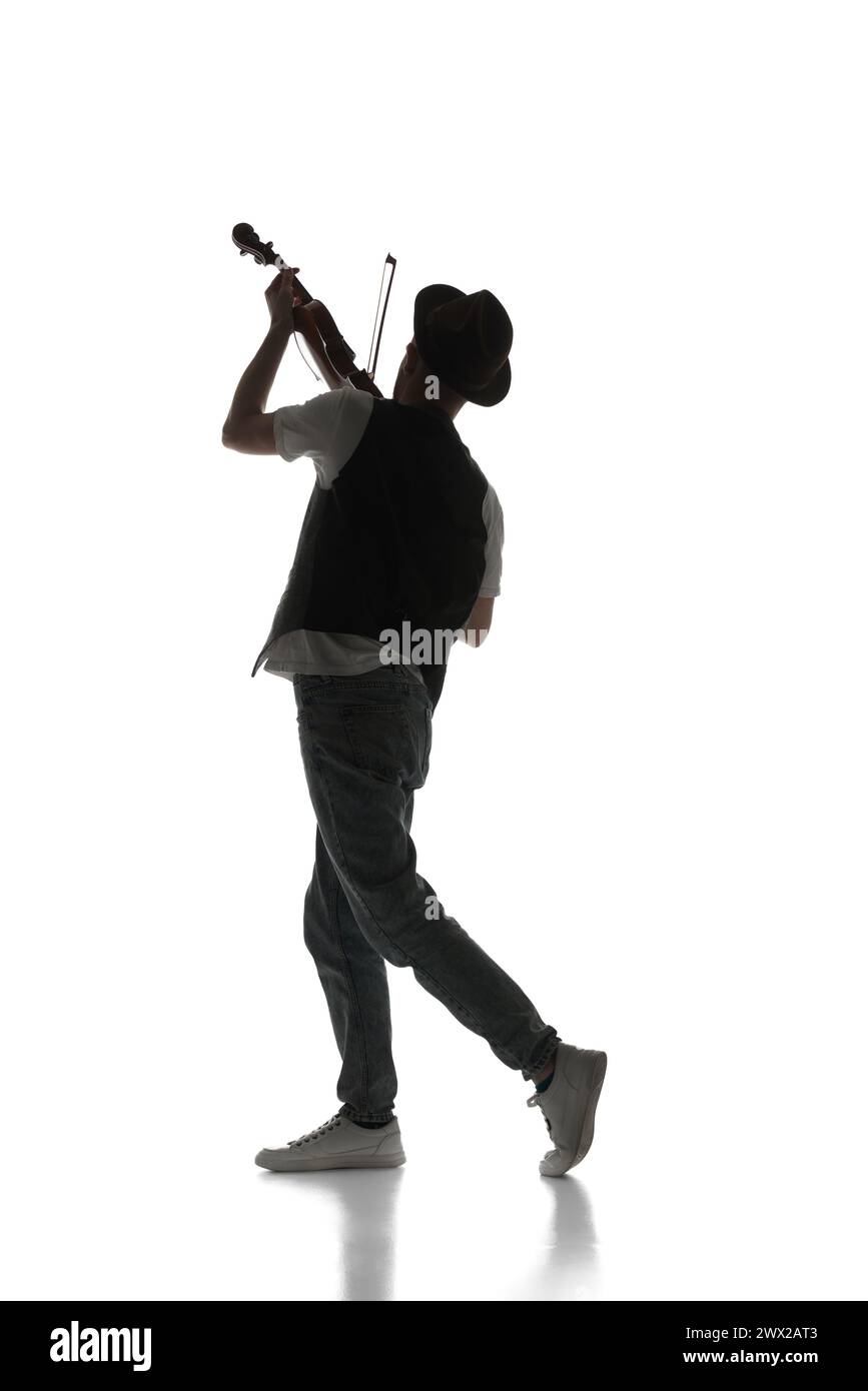 Male silhouette, talented young musician playing violin isolated on ...