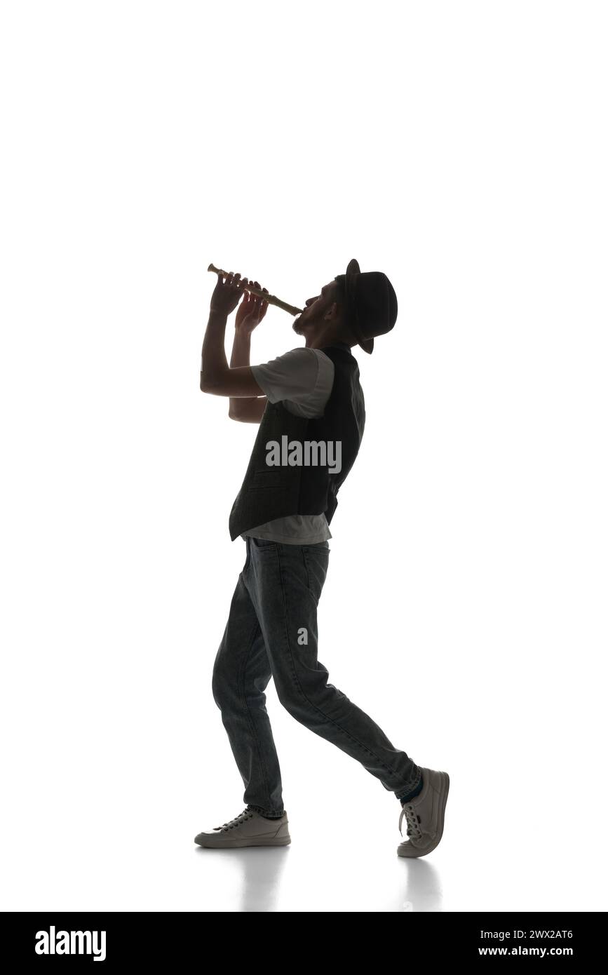 Male silhouette, talented young musician playing flute isolated on ...