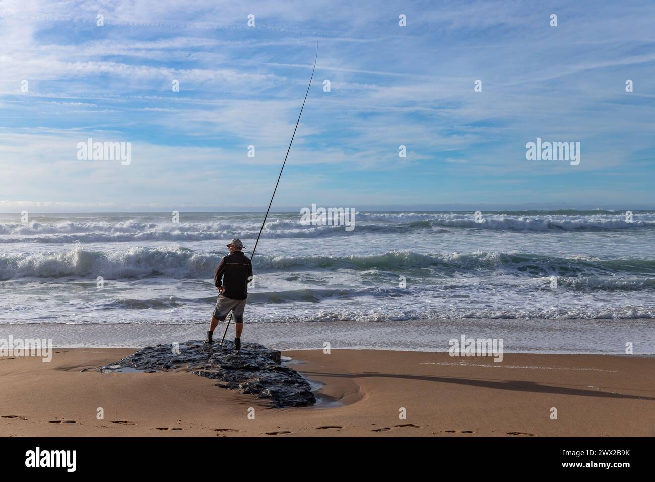 Sintra, Portugal: February 17, 2024: Fisherman using a rod and line ...