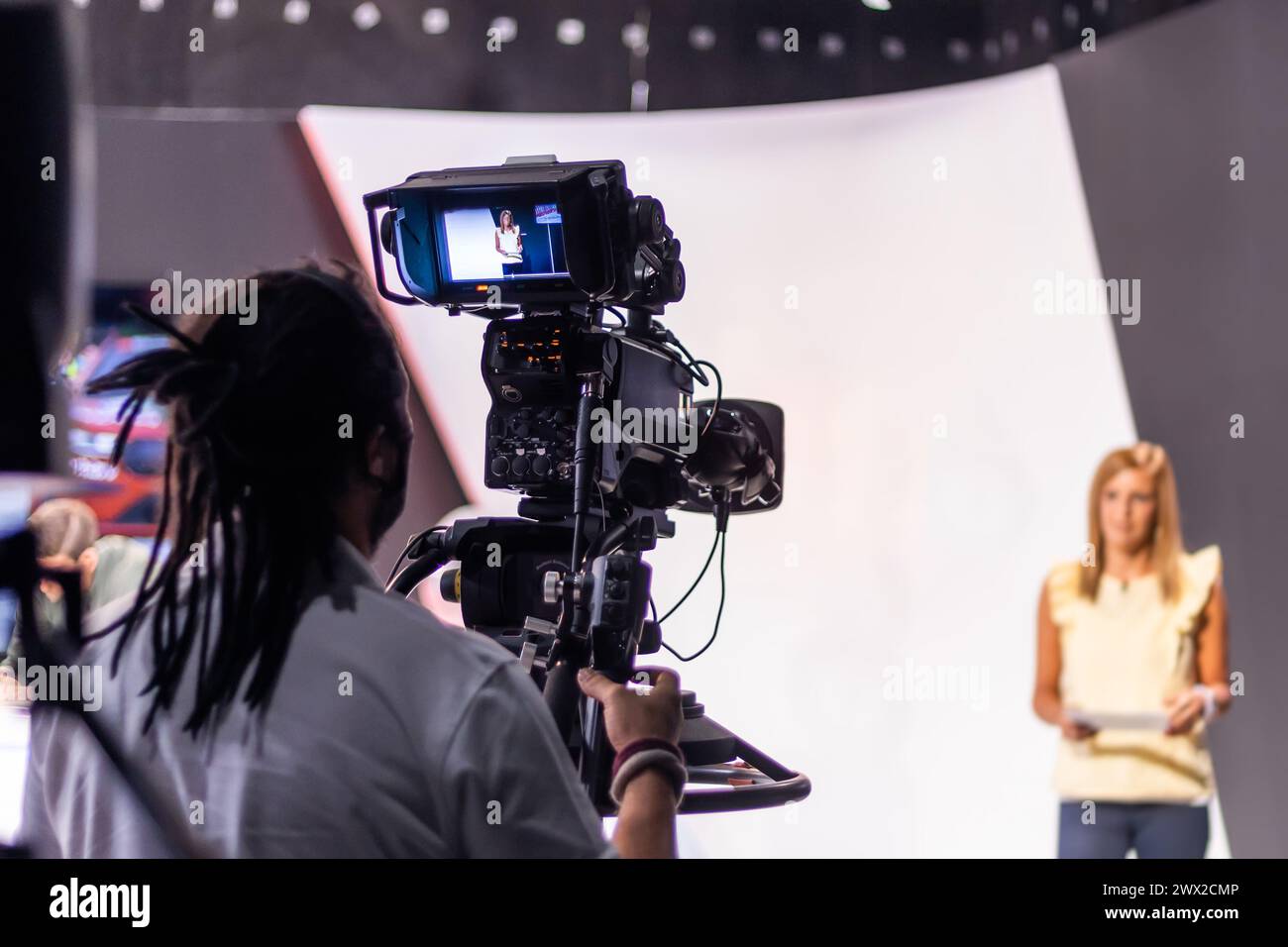 unrecognizable camera operator recording television program at the ...