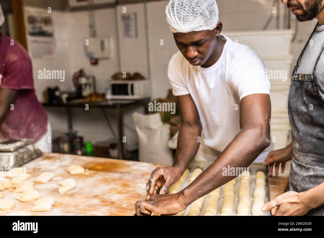 young black man classmates learning how to make cakes from master ...