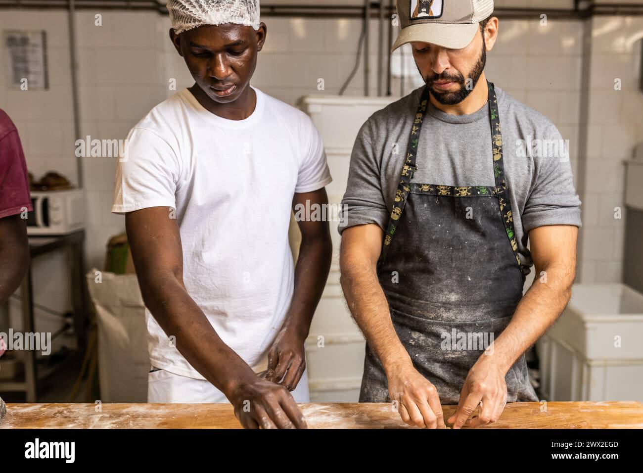 young black man classmates learning how to make cakes from master ...