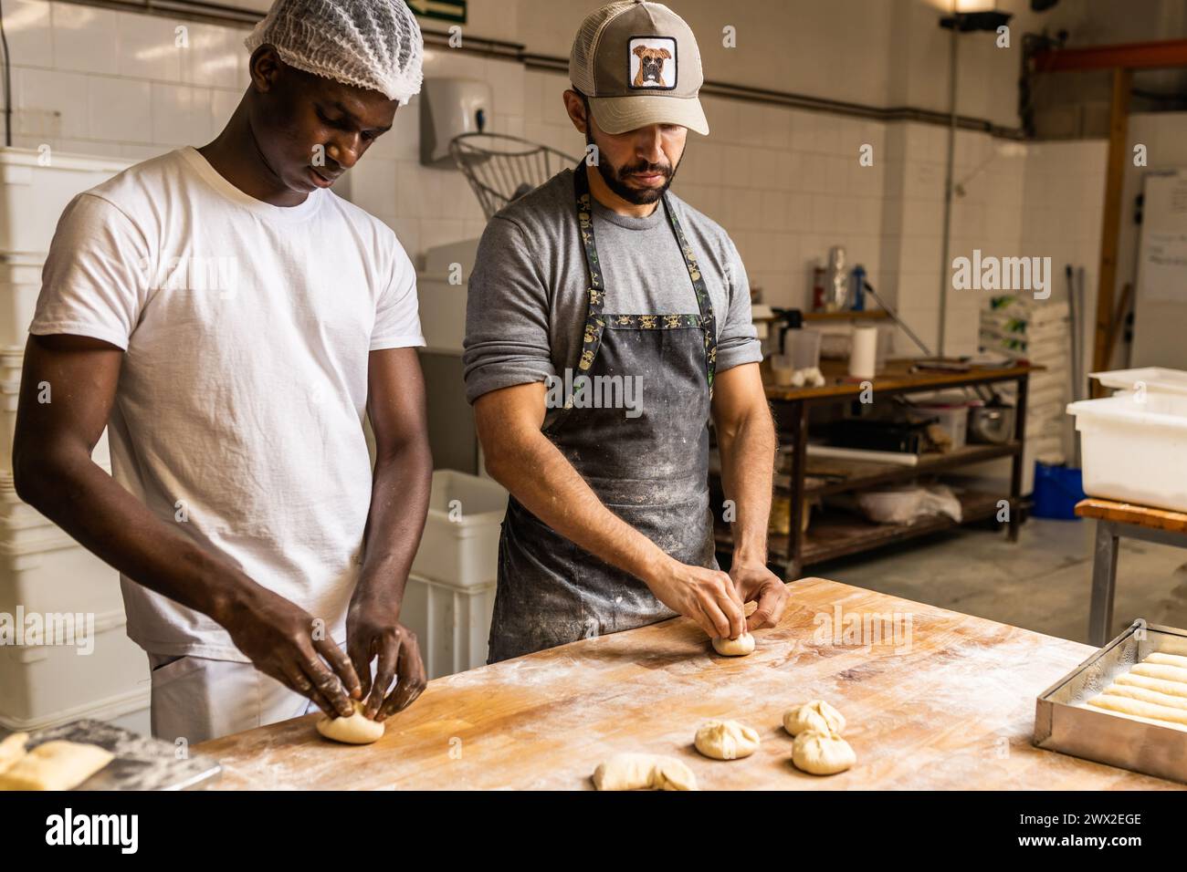 young black man classmates learning how to make cakes from master ...