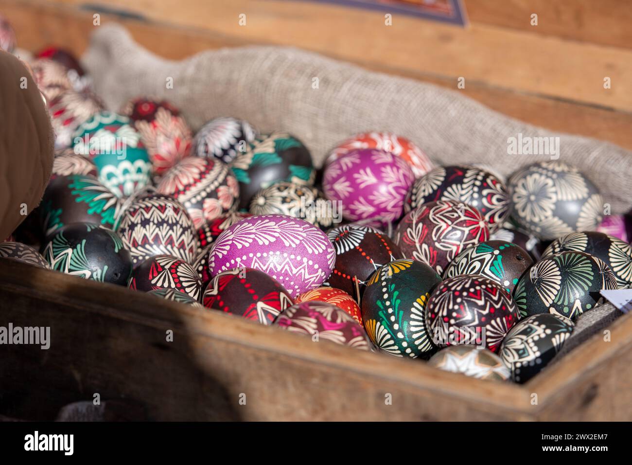 Traditional Lithuanian wooden colorful Easter eggs in a wicker basket ...