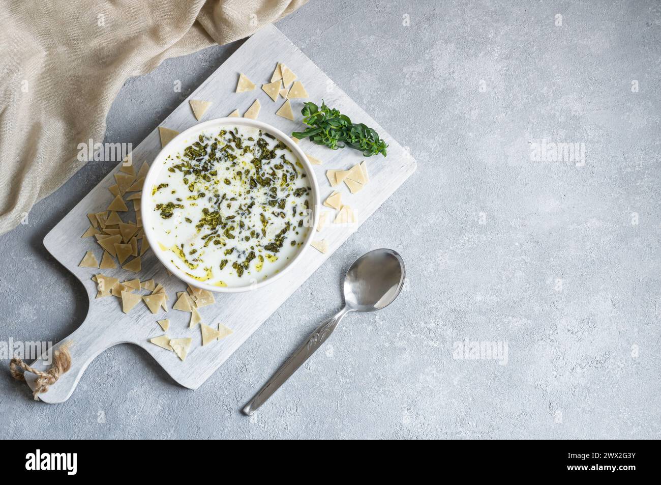 Traditional turkish homemade triangular cut yoghurt dough soup with oil ...