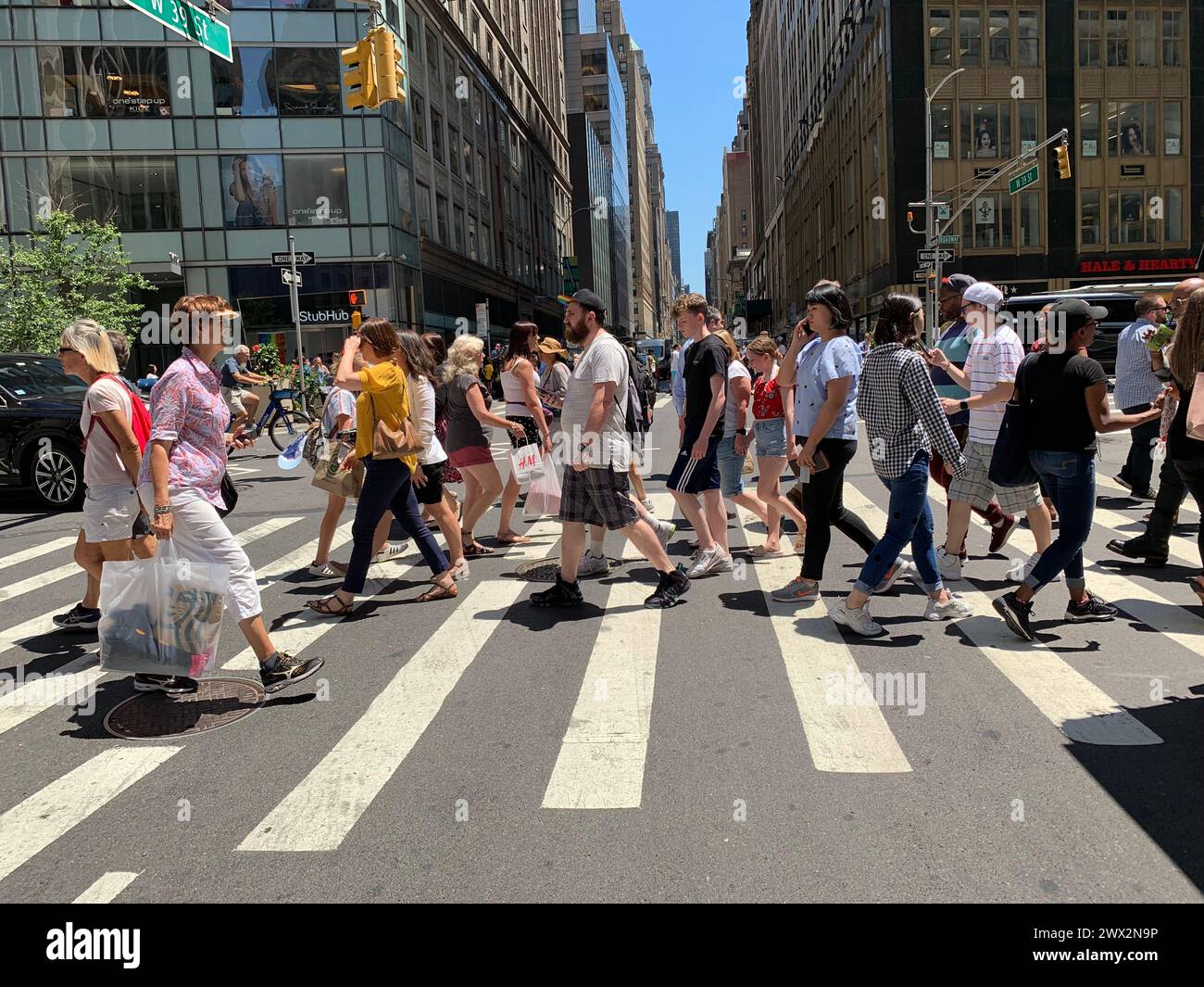 Pedestrians and travelers walk and cross the street using the crosswalk ...