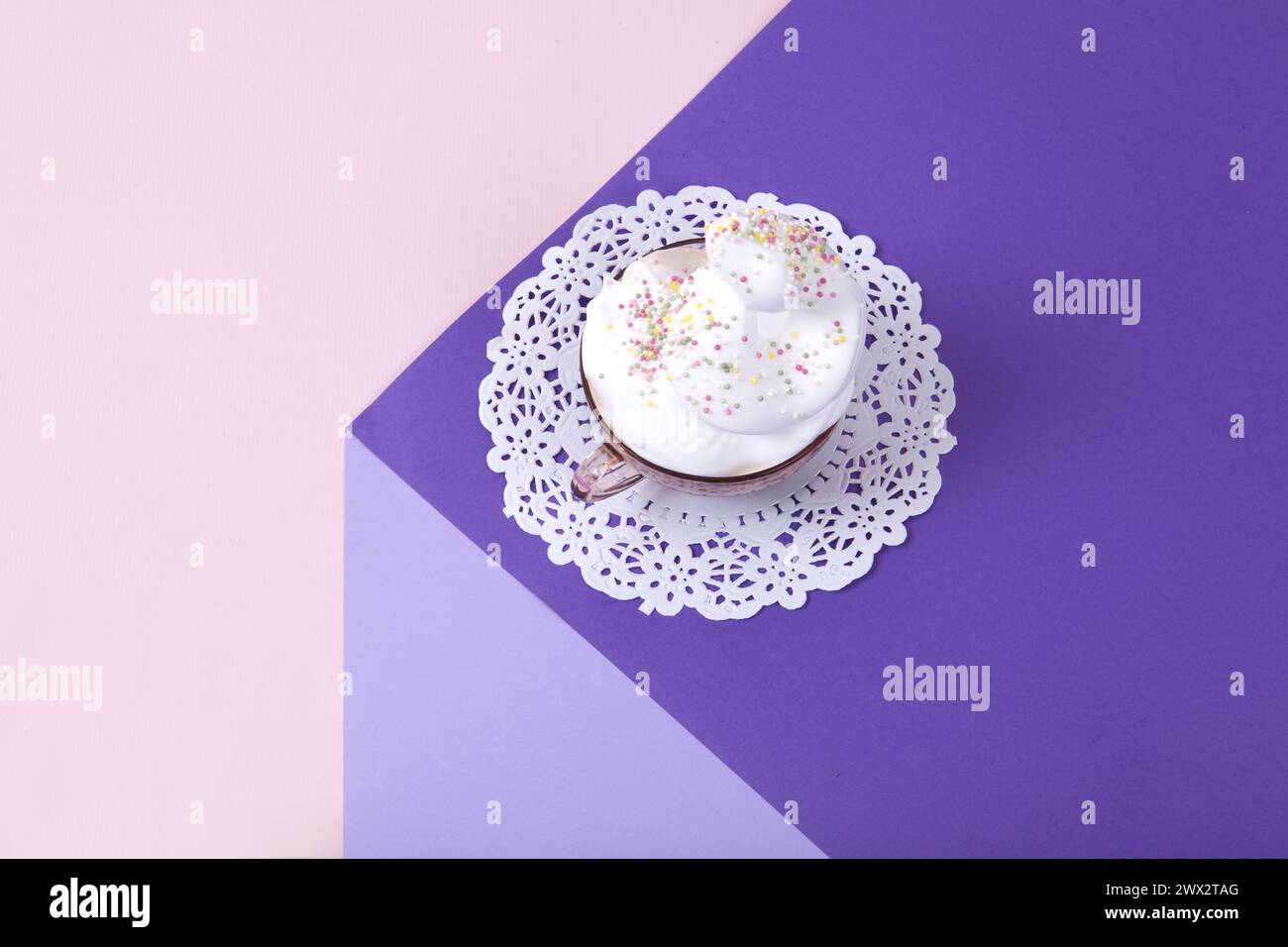 a violet cube made with colored paper to create a 3D optical illusion ...