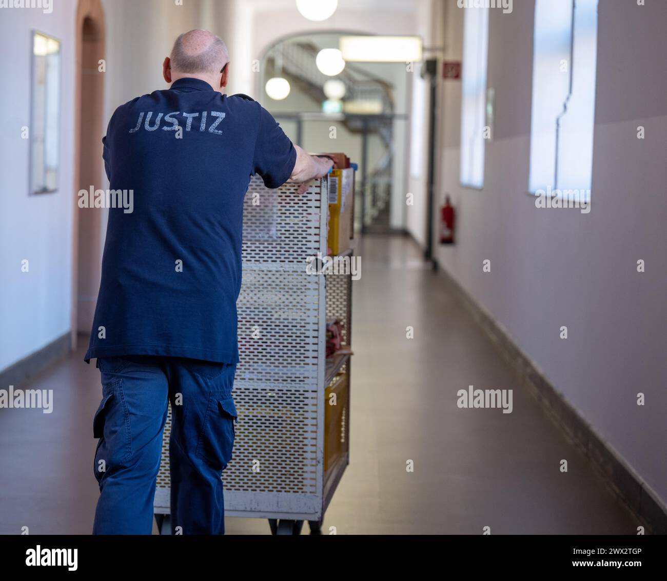Berlin, Germany. 27th Mar, 2024. A prison officer pushes a full file ...