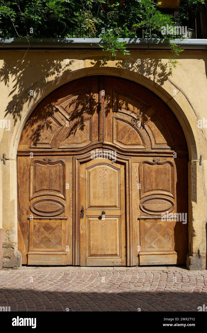 Old historic oak entrance gate on a house in the old town of Colmar in ...