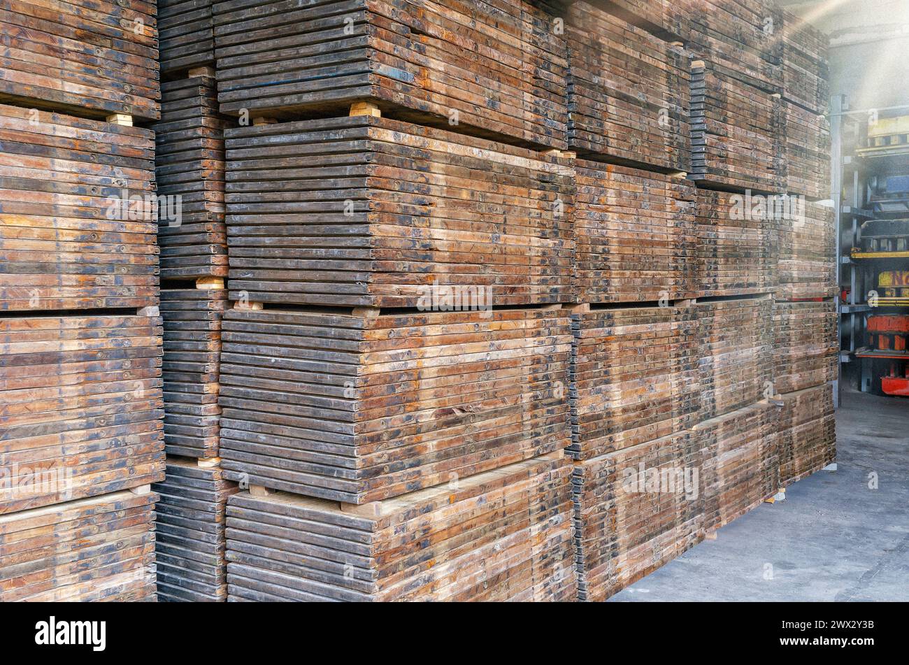 Stacks of wooden pallets. Interior of production warehouse. Plant for ...