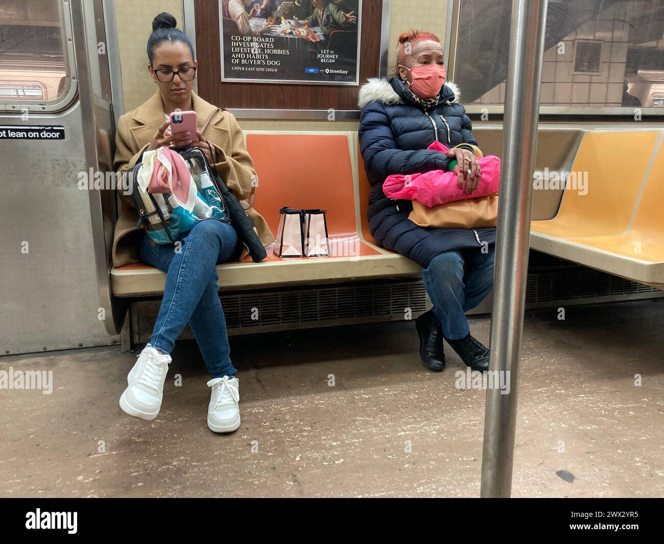 Riders in the subway in New York on Sunday, March 17, 2024. (© Frances ...
