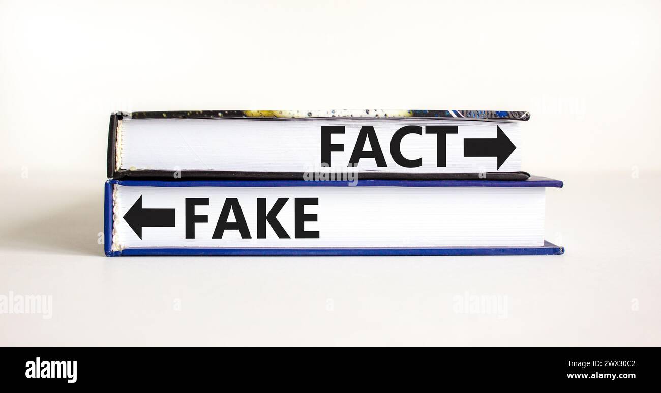 Fact or fake symbol. Concept word Fake and Fact on beautiful books ...