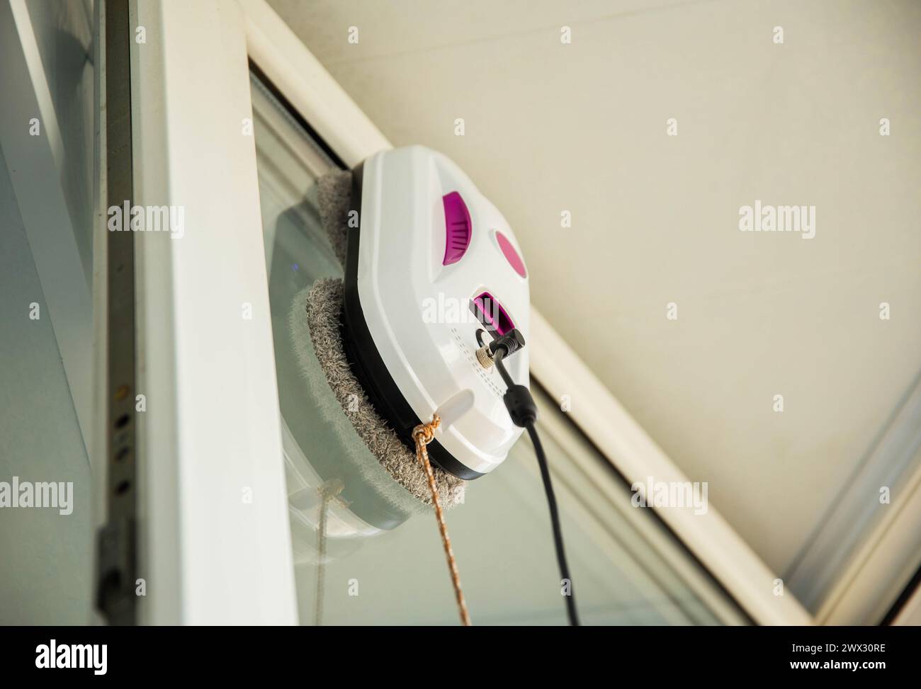 Automatic vacuum robot window cleaner washes glass in the apartment ...