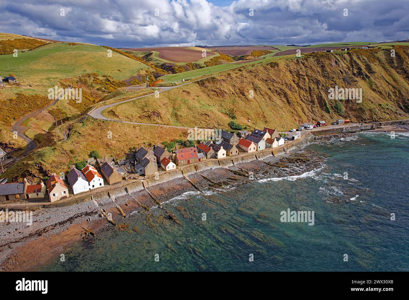 Crovie Aberdeenshire Scotland the road leading to a row of houses below ...