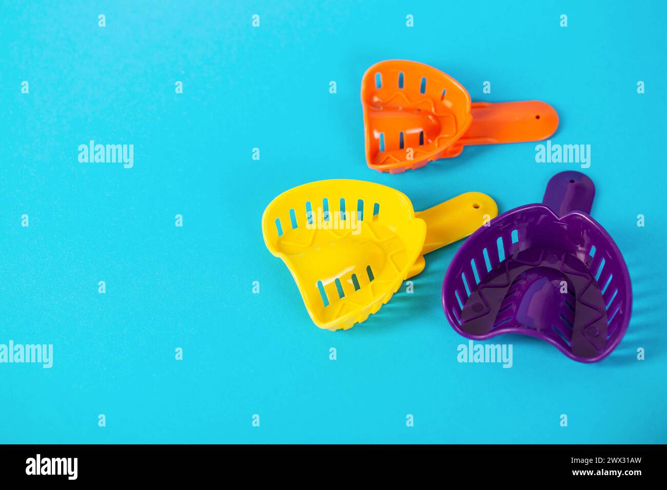 Multi-colored dental spoons for taking an impression of the dental jaw ...