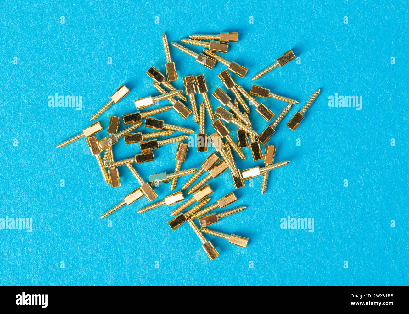 Lots of metal dental pins on a blue background. The concept of ...