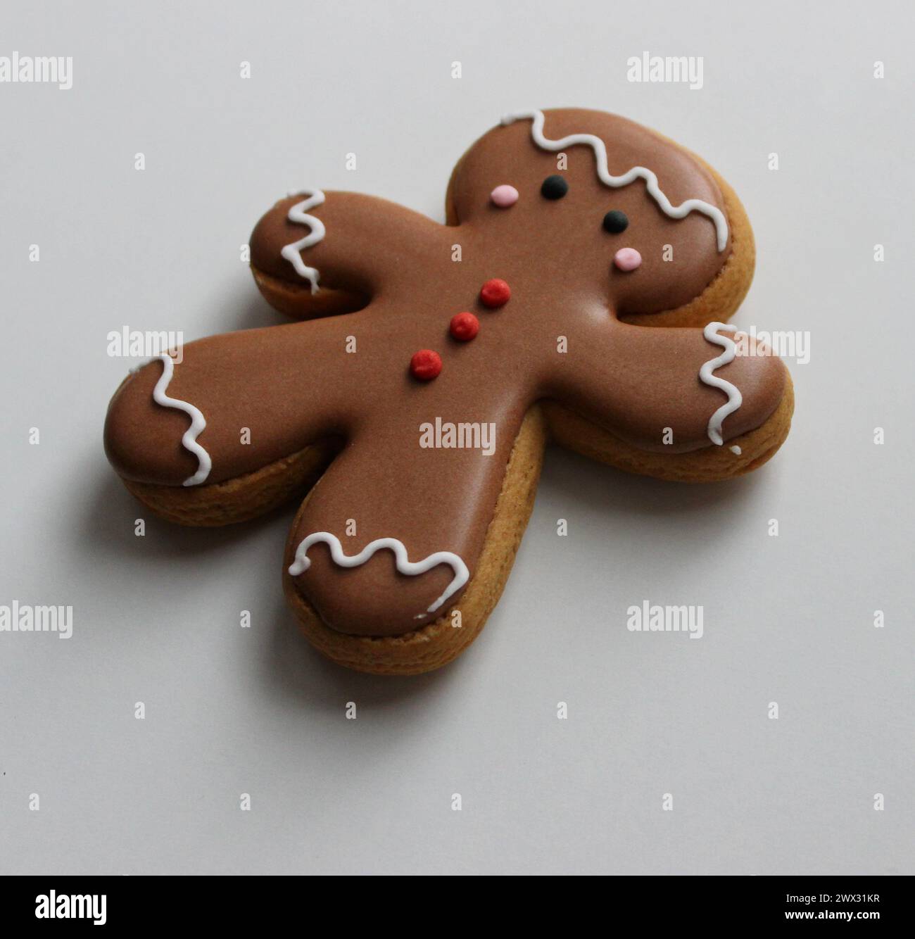 Traditional cookie covered with sweet icing in the shape of a man on a ...