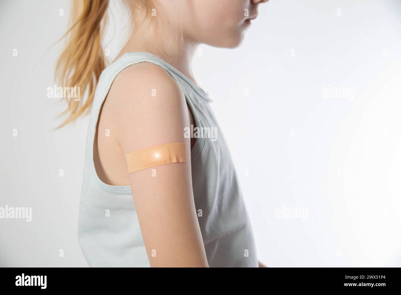 Plaster on the hand of a girl child after vaccination against influenza ...