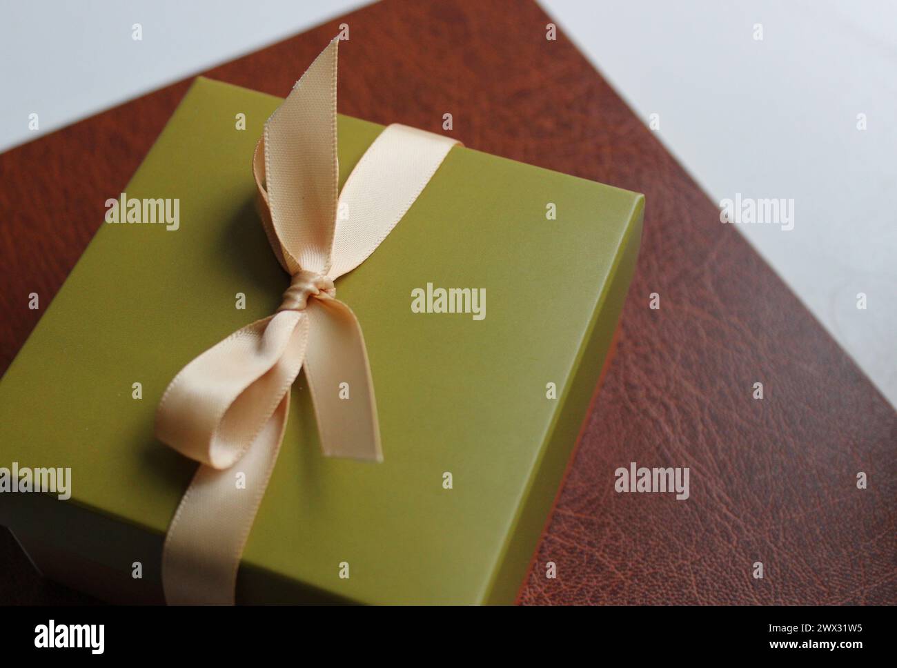 Gift box in a simple business style on a leather folder for papers ...