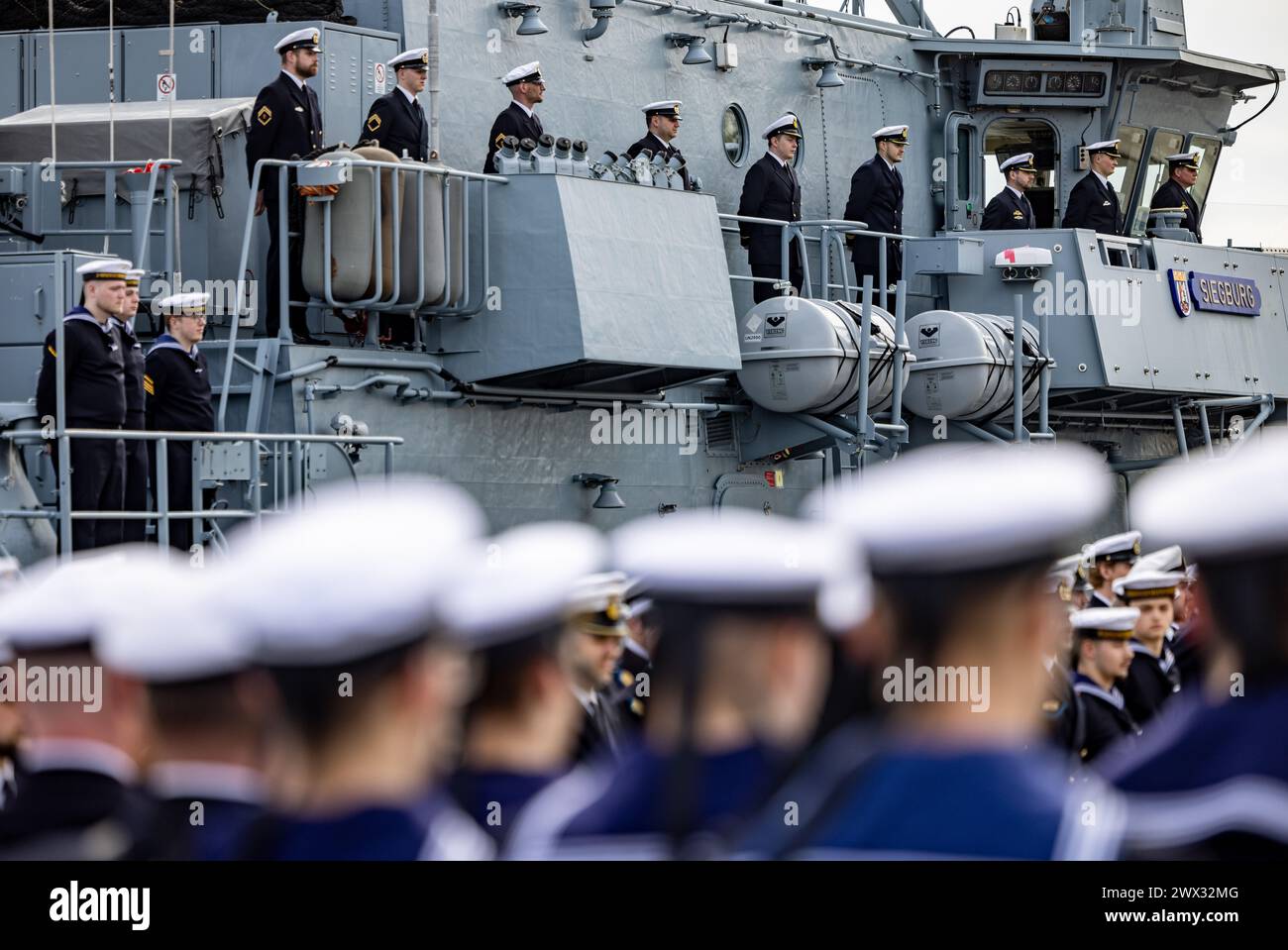 Kiel, Germany. 27th Mar, 2024. Marines have lined up to hand over ...