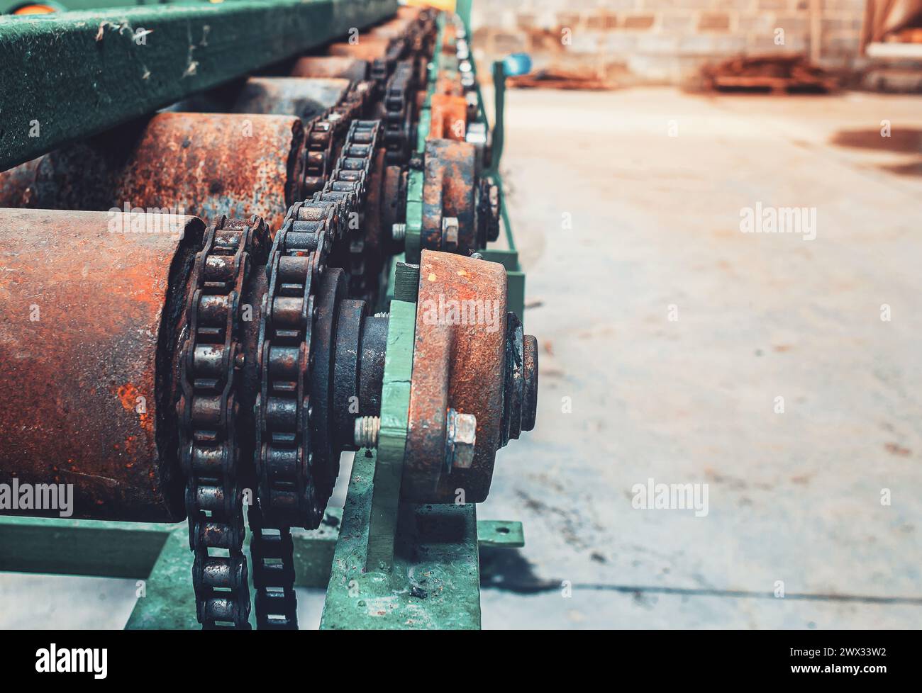 Old broken transmission machine. Rusty metal chain, transmission shafts ...
