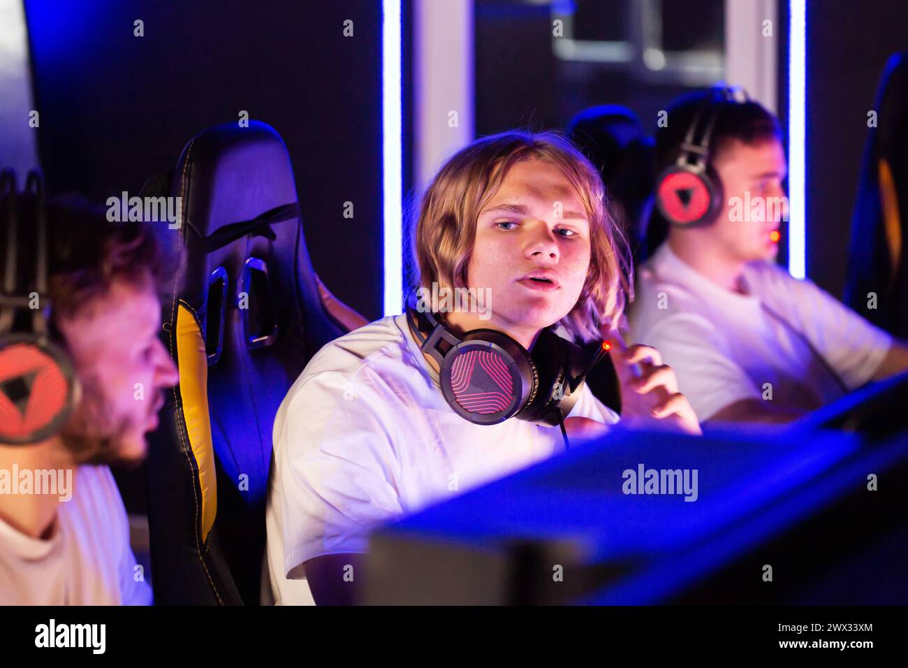 Pimply teen gamer puts on headset at PC computer club, cyber sport ...