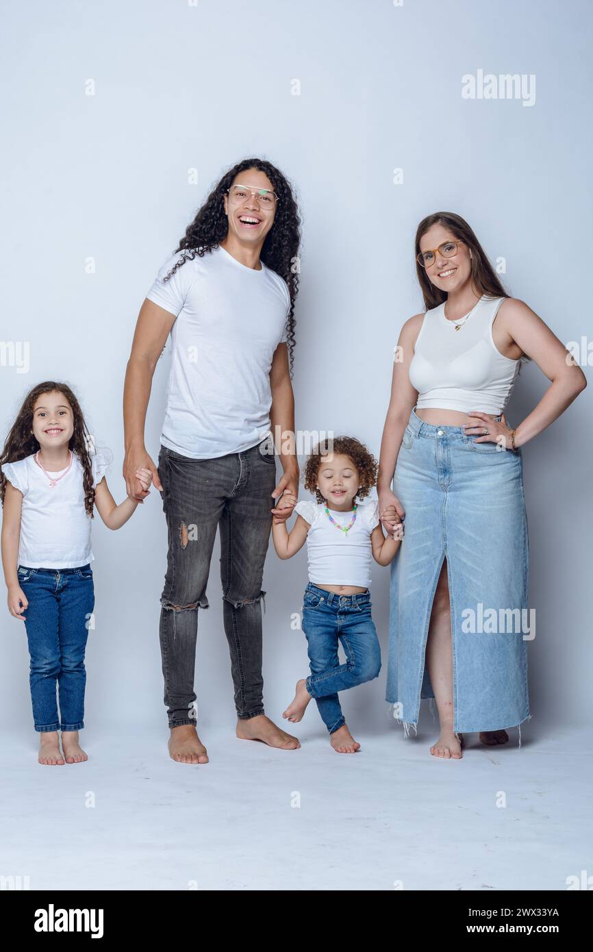 young latin family of father mother and two young girls daughters ...