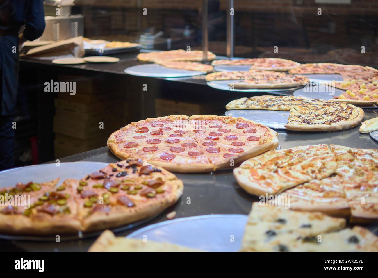 This image shows a variety of gourmet pizzas with different toppings ...