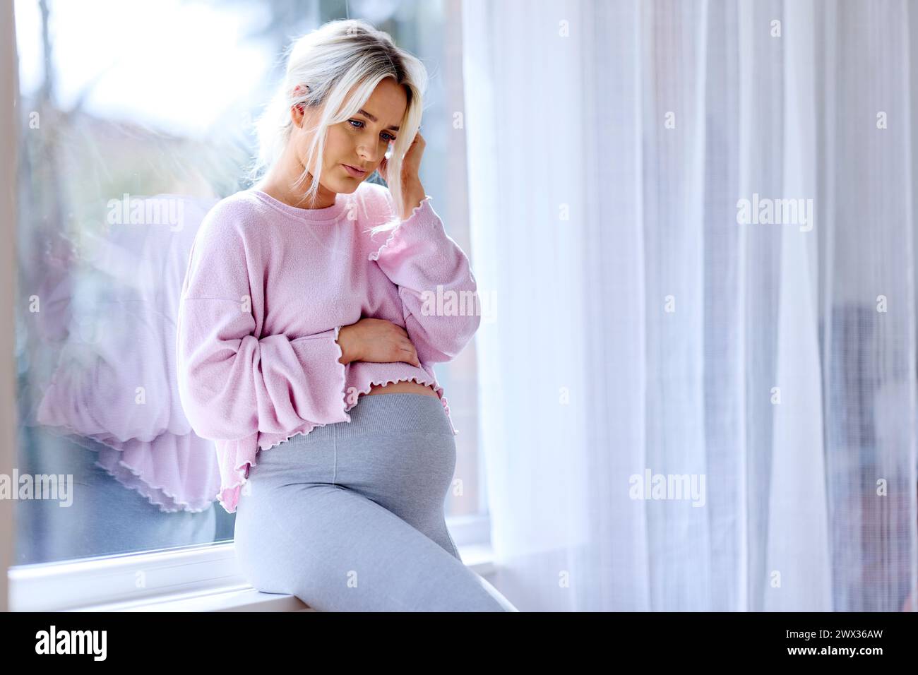 Sad looking pregnant woman Stock Photo - Alamy