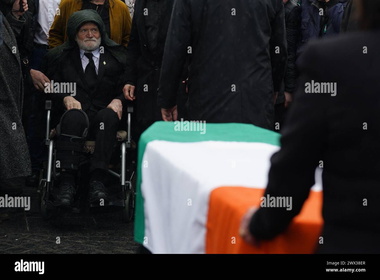 Jim Monaghan (in wheelchair), attends the funeral service of veteran ...