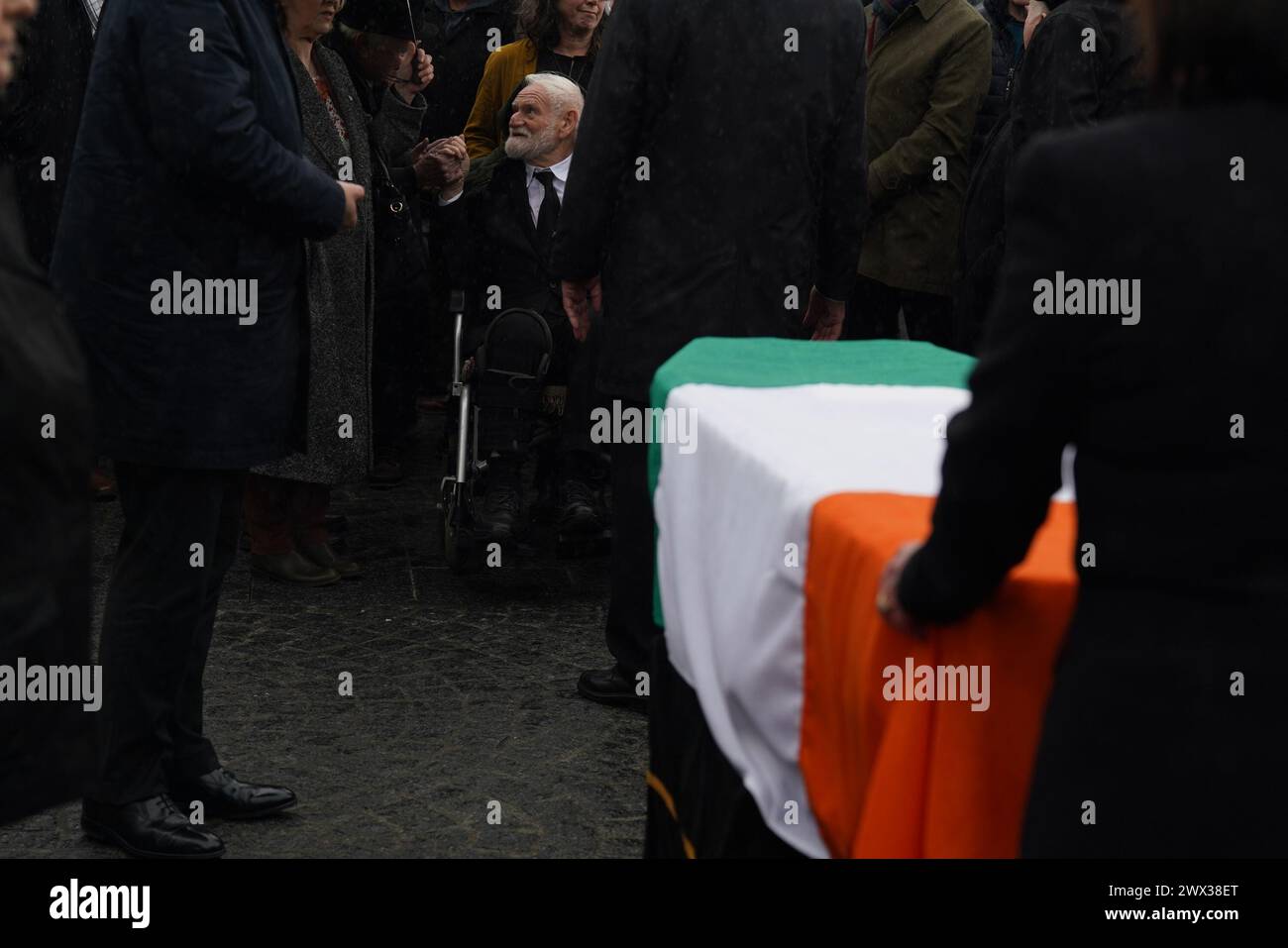 Jim Monaghan (in wheelchair), attends the funeral service of veteran ...