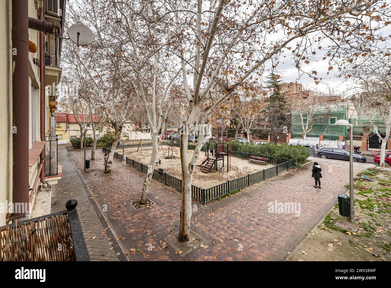 Urban plaza with a children's play area with perimeter fence and ...