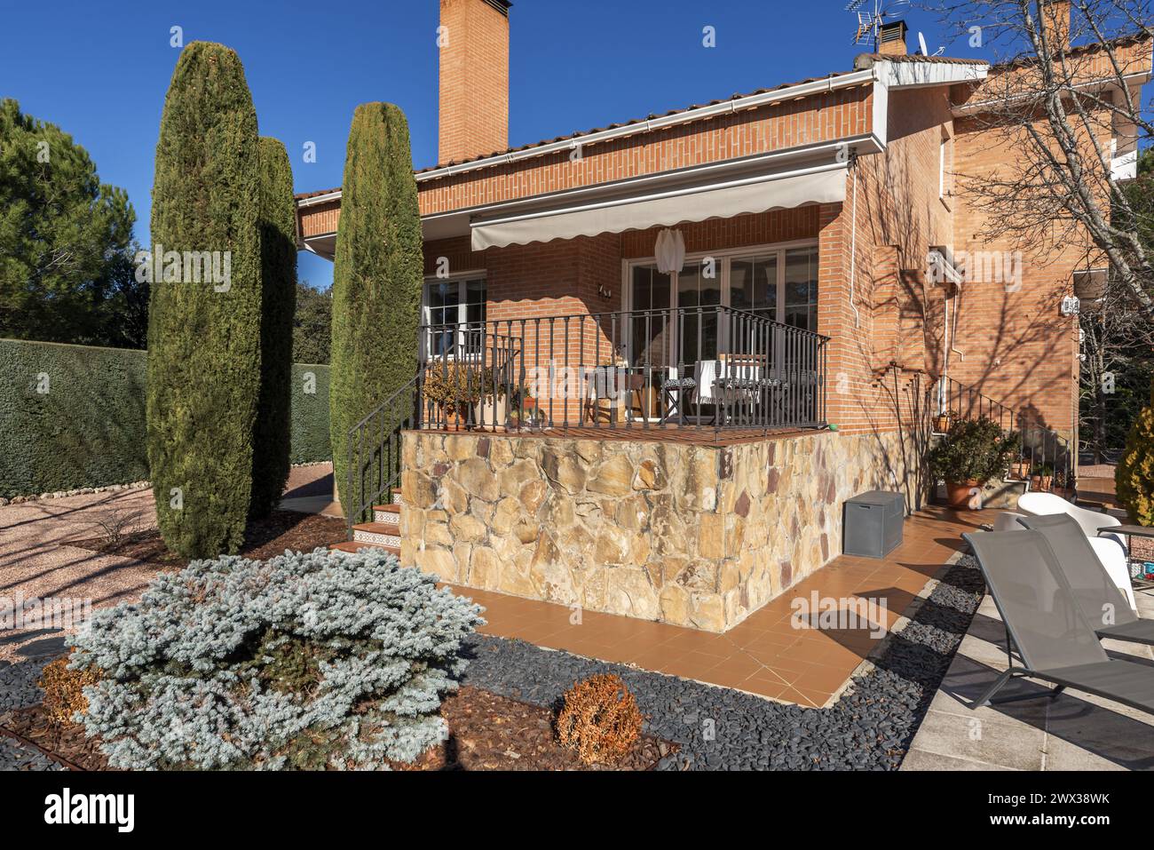 Detached chalet with gravel floor, some cypress trees inside, porch ...