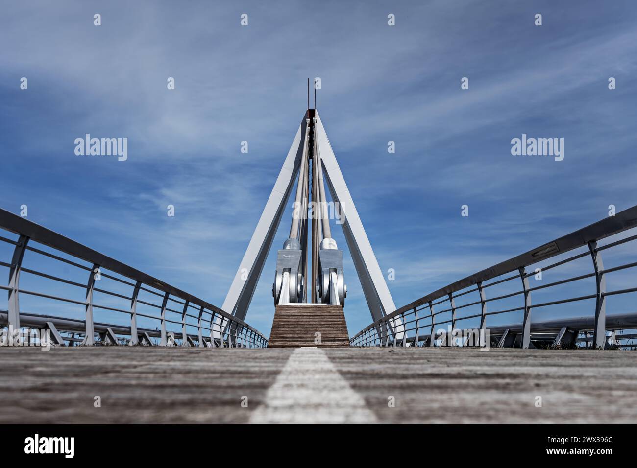 A bridge with a wooden pedestrian walkway floor with paint marks and ...