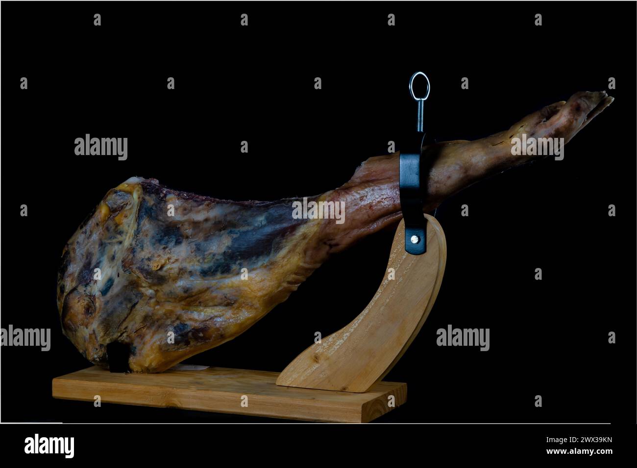 Spanish acorn-fed iberian ham close-up on black background and copy ...