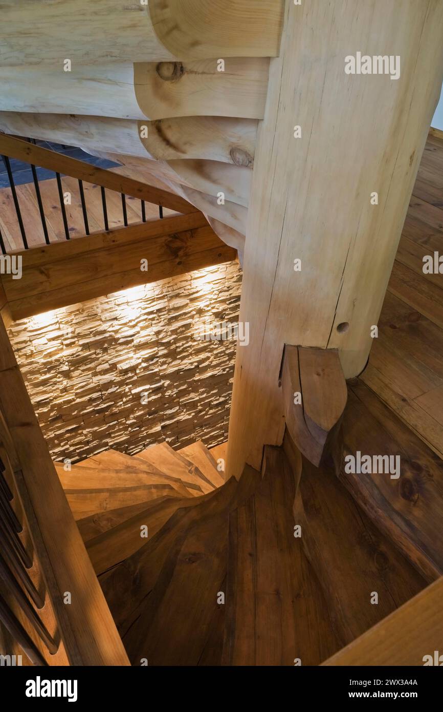 Wood and black wrought iron handrails surrounding steep twisting ...