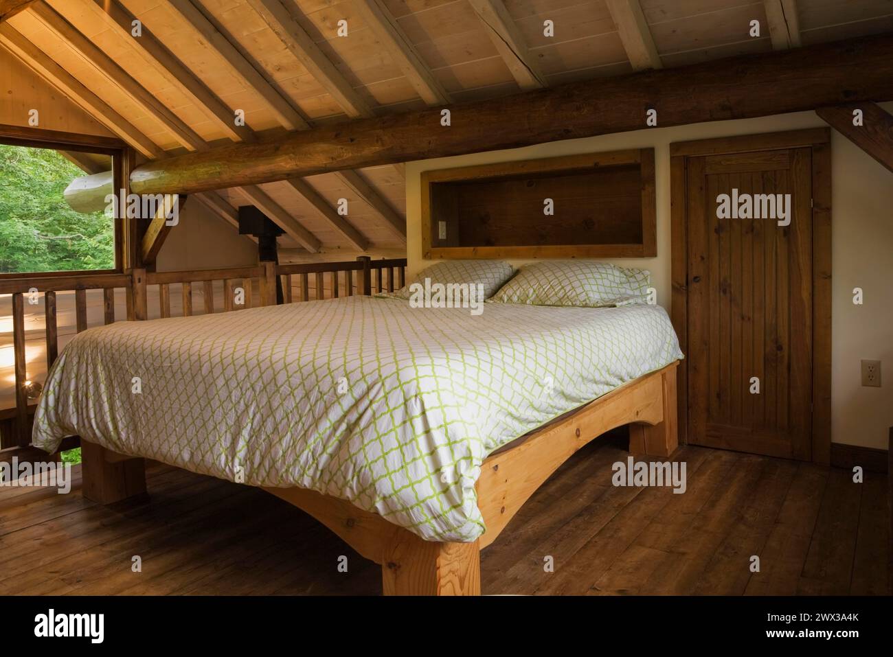 King size bed with pine wood frame in sparsely furnished Zen stmaster ...