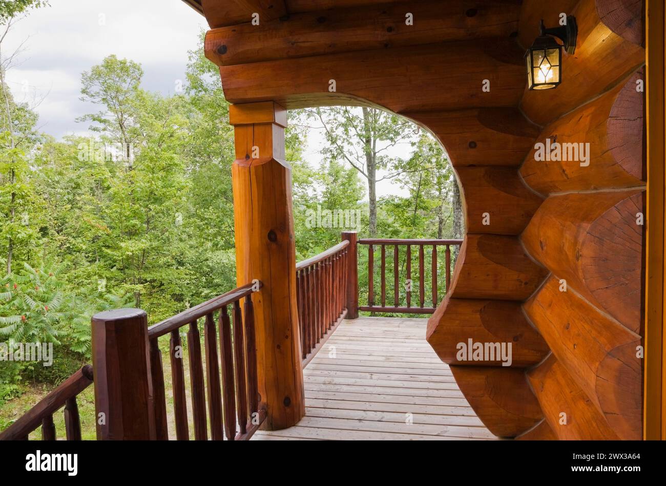 Brown reddish stained Scandinavian log cabin home with with arch and ...