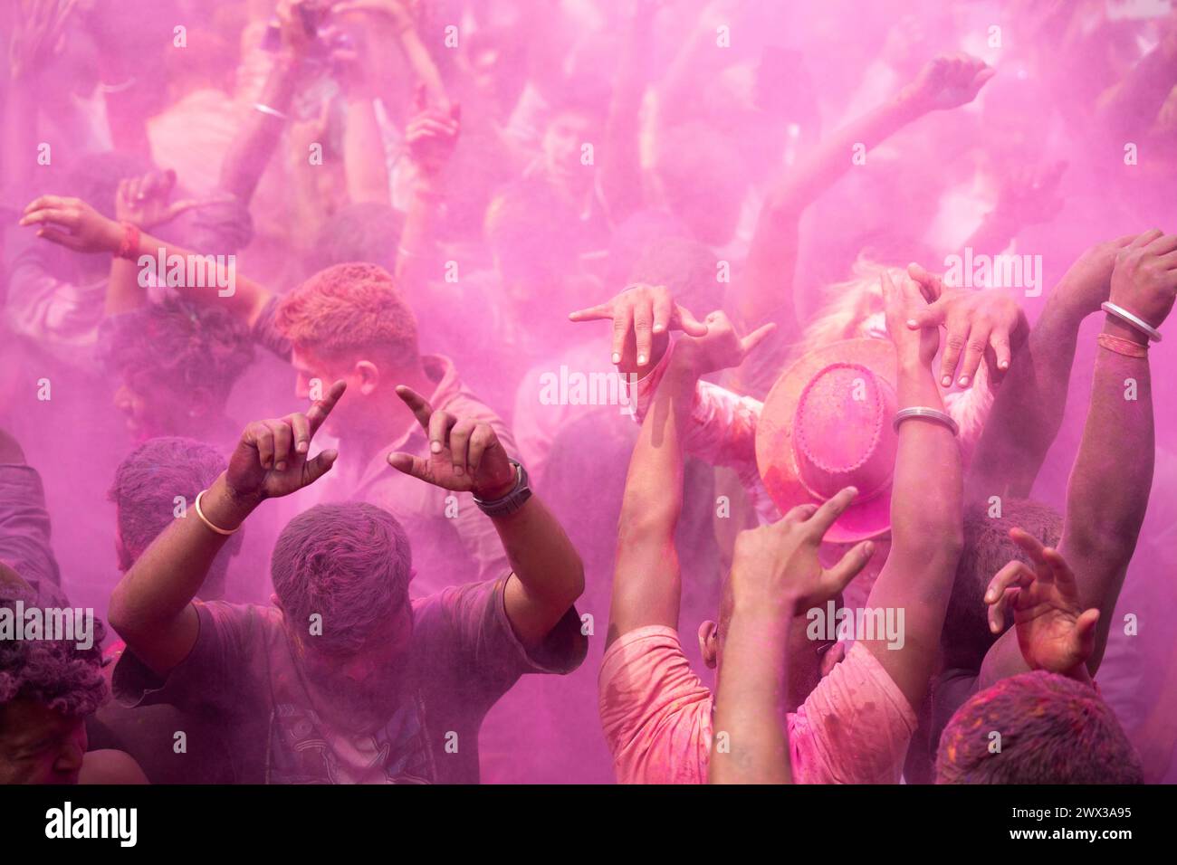 Revellers dancing in the beat of music as they celebrate Holi on a ...