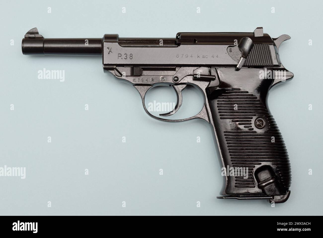 Left side of WWII German Walther P38 9mm pistol on blue background ...