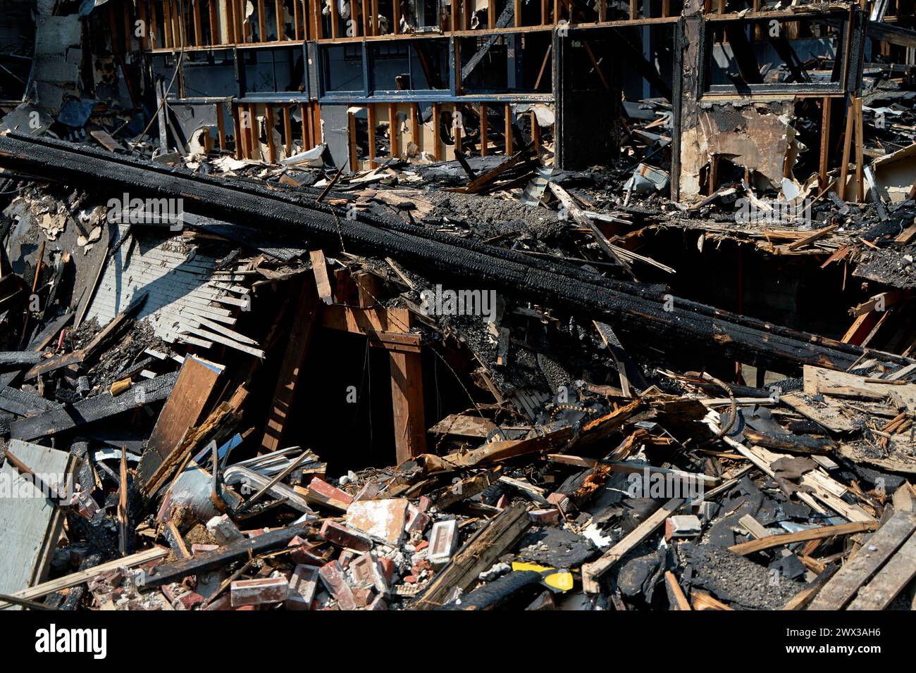 A burnt-out old wooden building after a fire. Charred beams after the ...