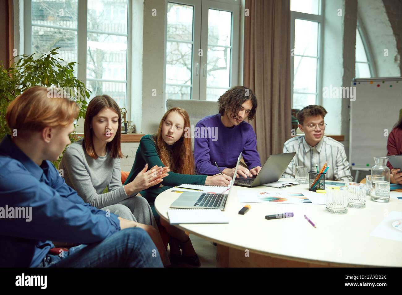 Students are studying in library. Young people are spending time ...