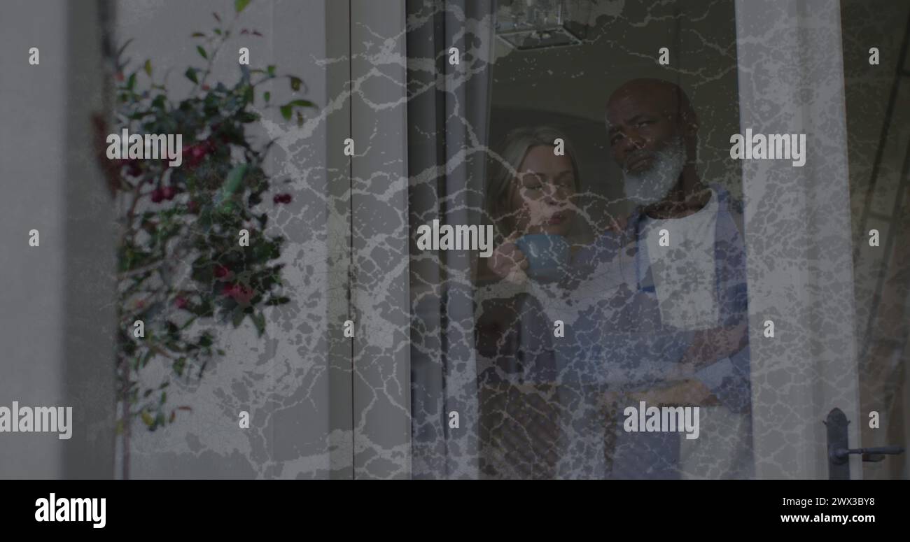 Image of moving background over sad senior diverse couple embracing ...