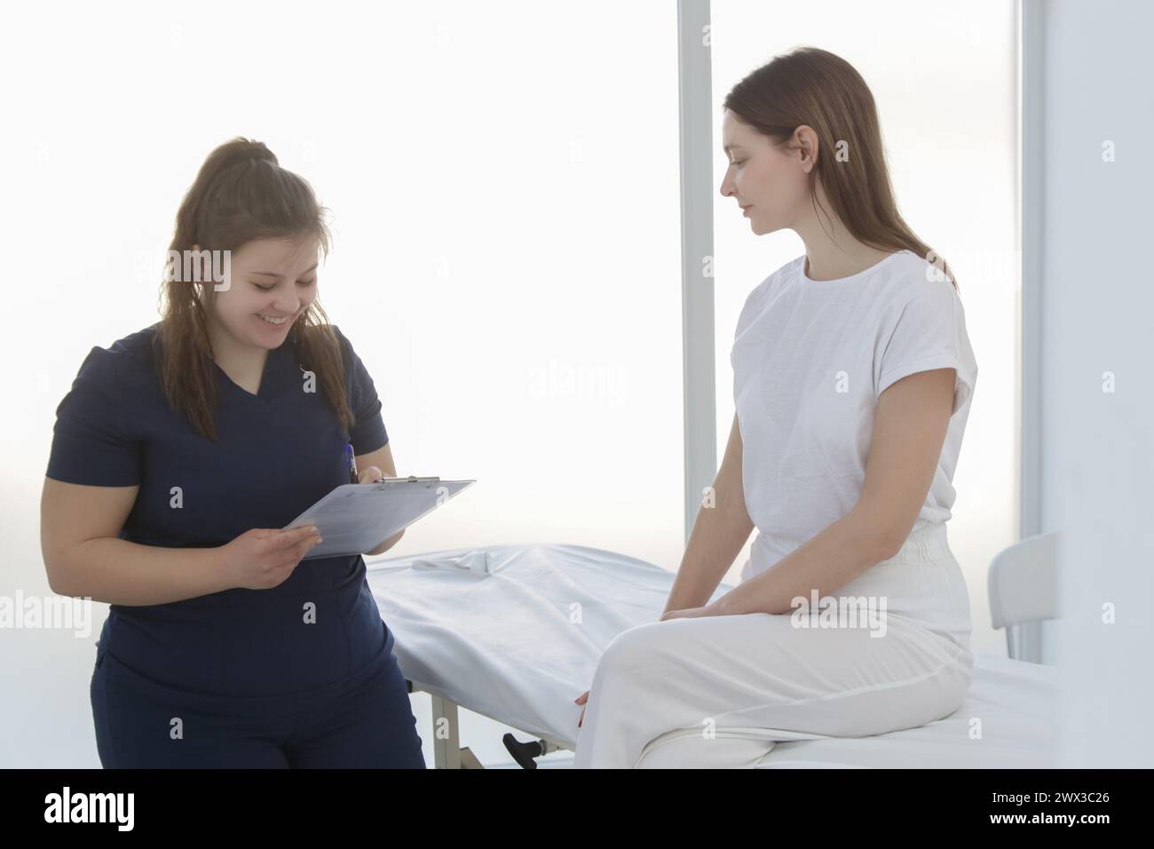 Woman at the doctors office on chiropractic, physiotherapy or ...